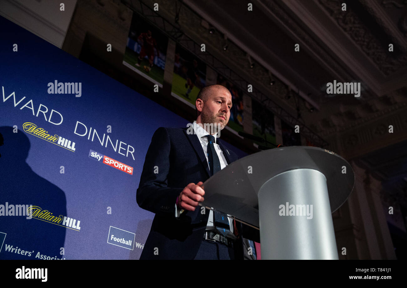 Dan Ellis accepts an award on behalf of his father Ralph during the FWA ...