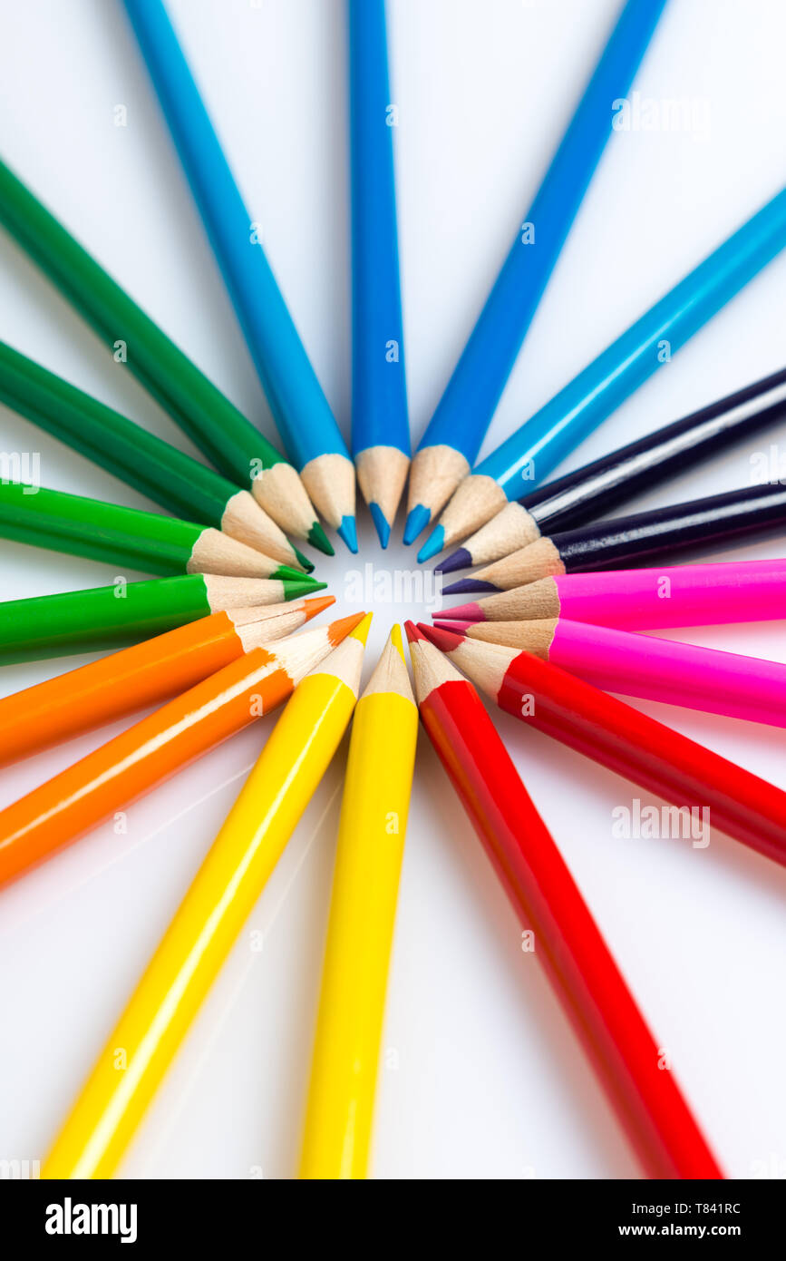 colourful still life with pencils and art supplies on white background ...