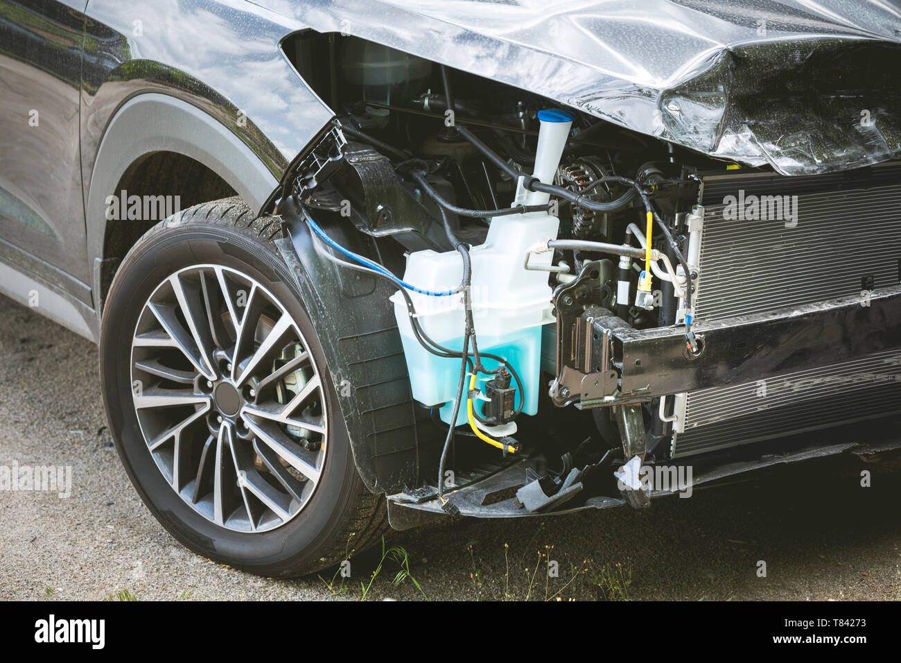 Broken and crashed modern grey car after an accident on street, damaged ...