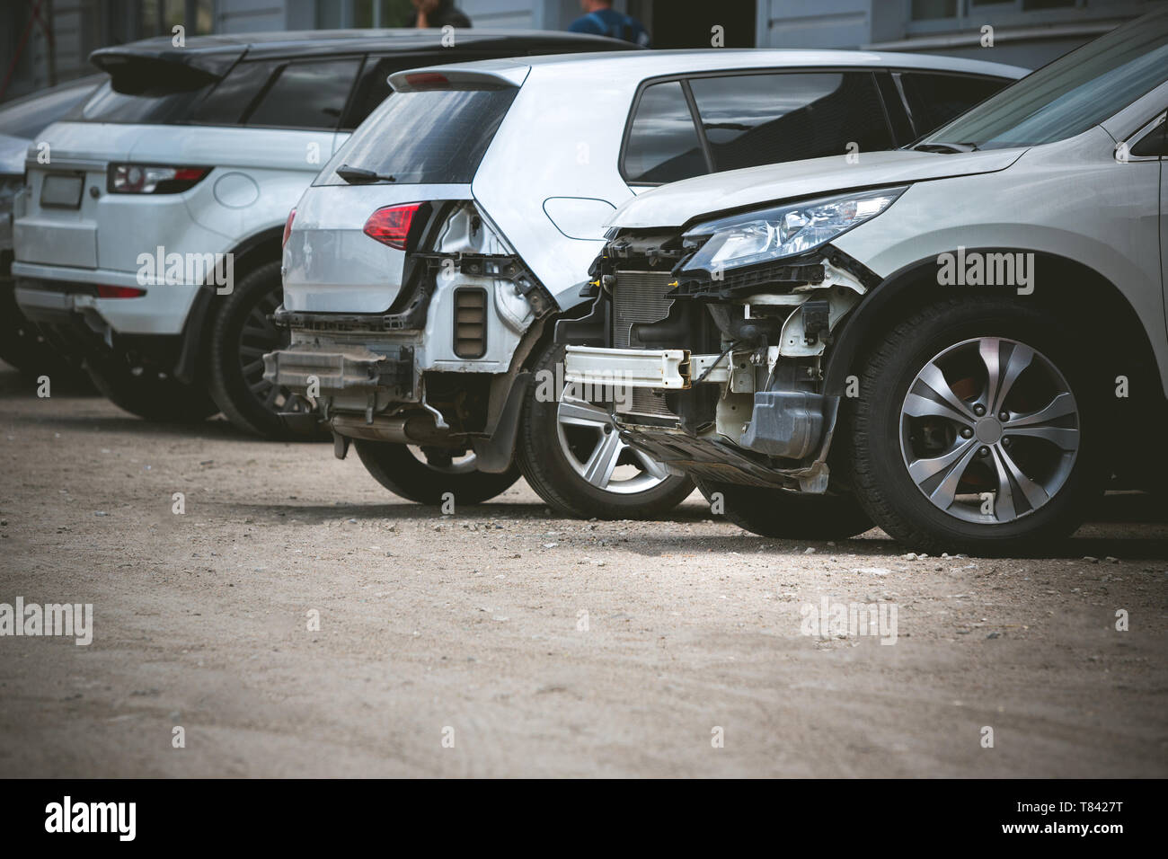 Broken and crashed modern cars after an accident on street, damaged ...