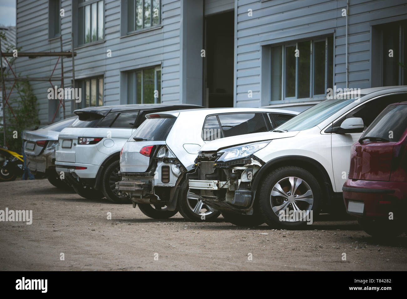 Broken and crashed modern cars after an accident on street, damaged ...