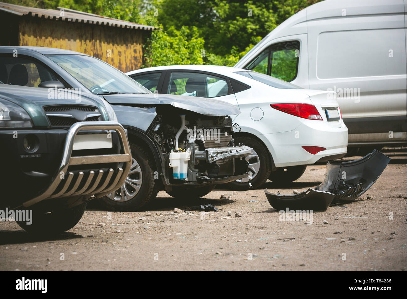 Broken and crashed modern cars after an accident on street, damaged ...