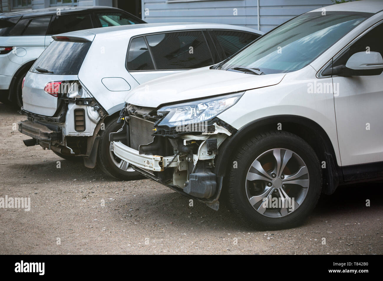 Broken and crashed modern cars after an accident on street, damaged ...