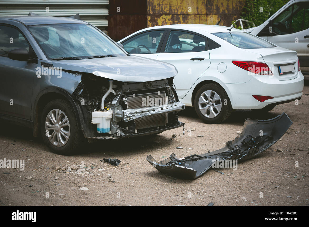 Broken and crashed modern cars after an accident on street, damaged ...