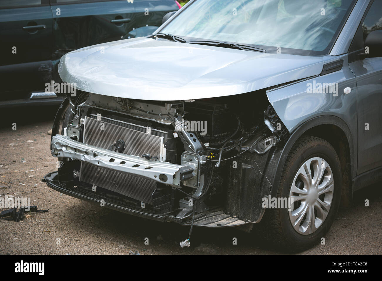 Broken and crashed modern grey car after an accident on street, damaged ...