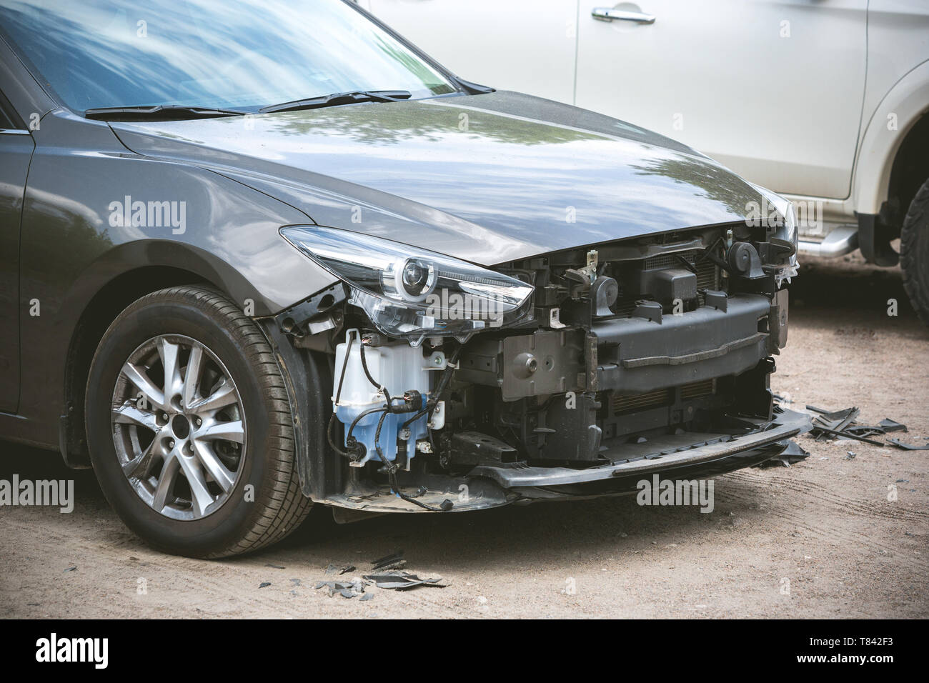 Broken and crashed modern black car after an accident on street ...