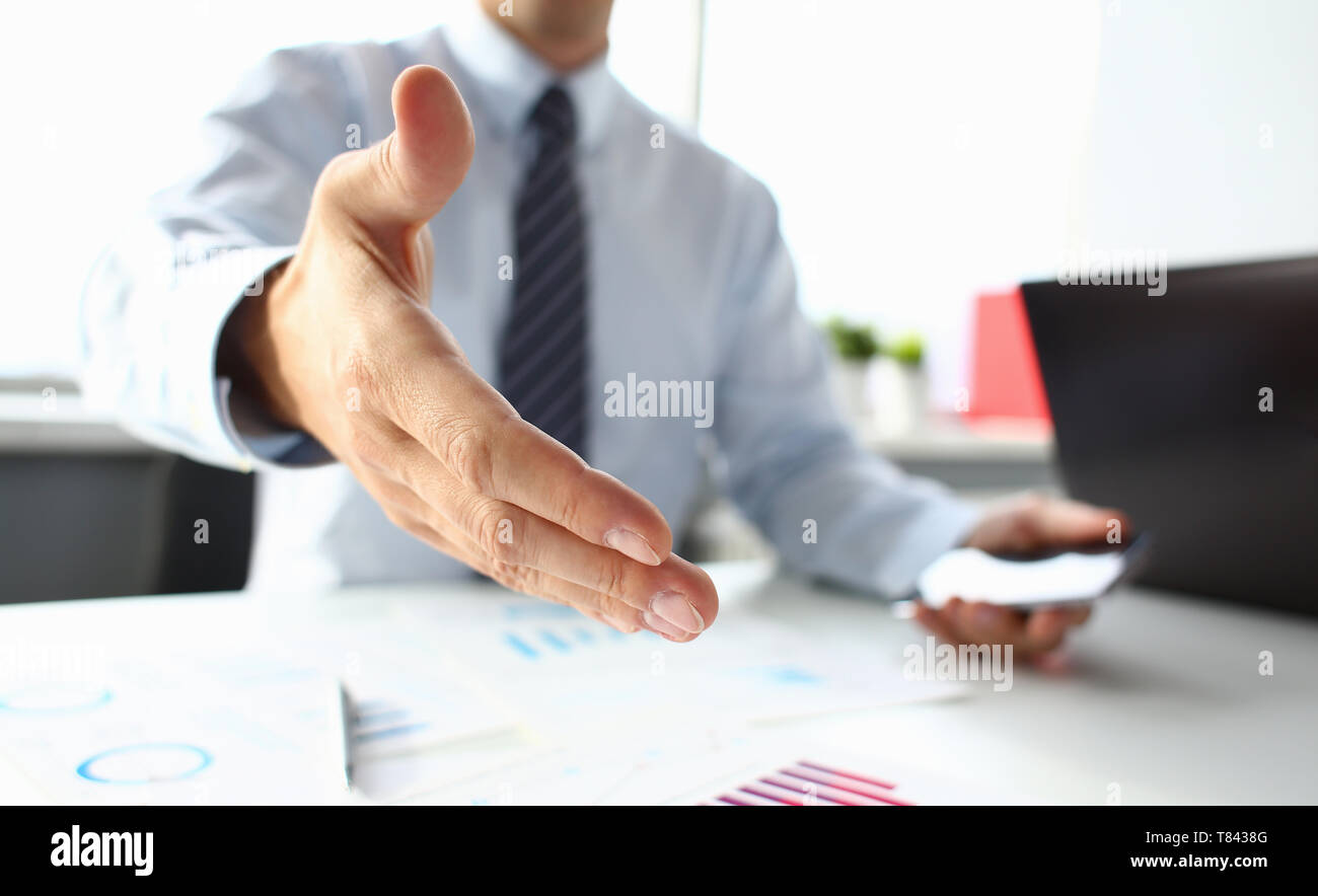 Man in suit and tie give hand as hello in office closeup. Friend ...