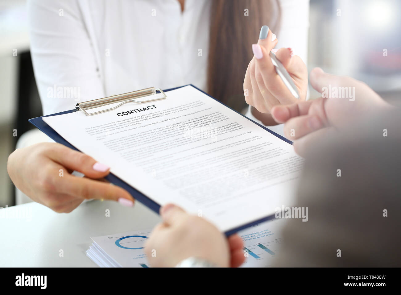 Female arm offer contract form on clipboard pad Stock Photo - Alamy