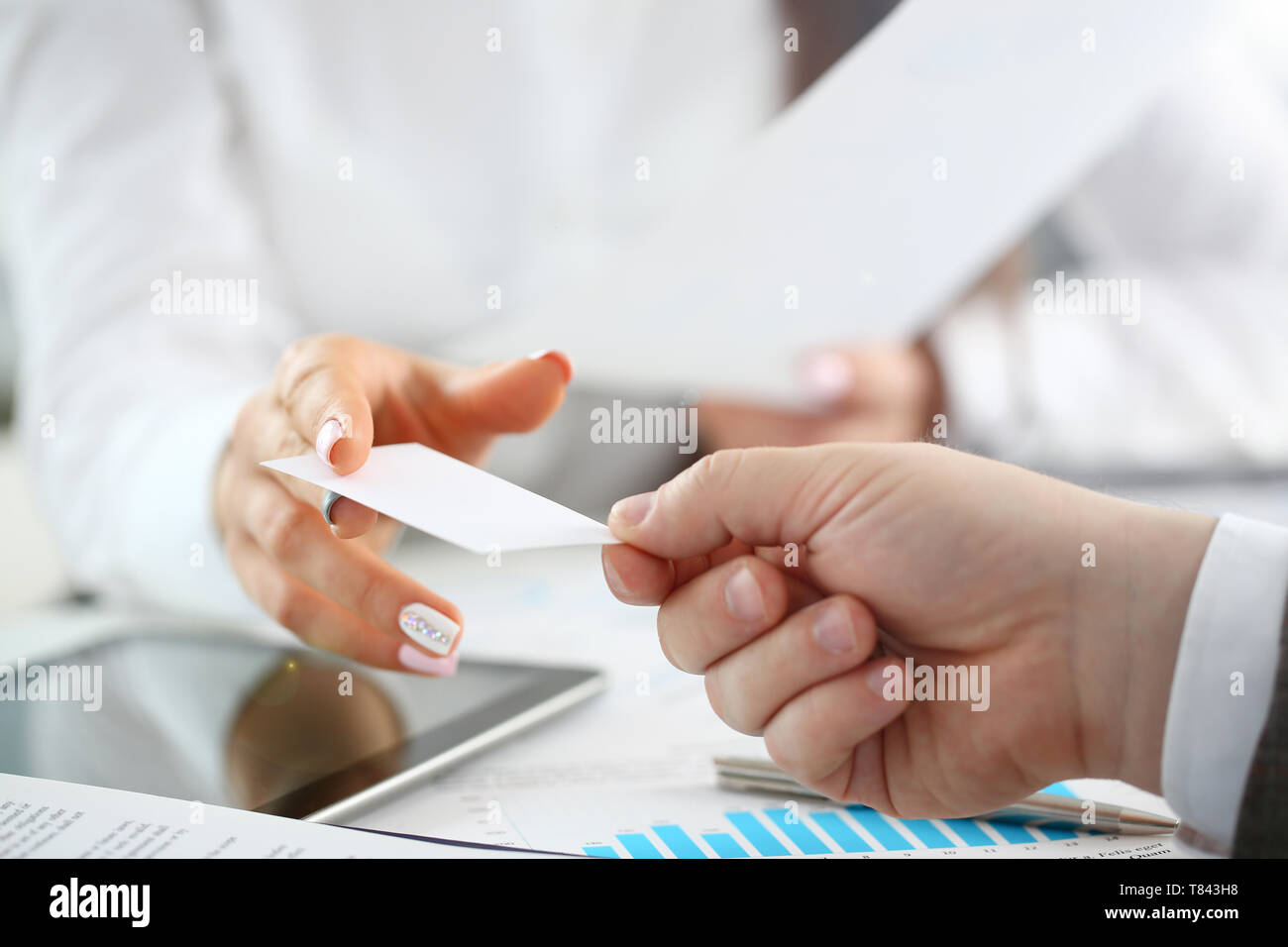 Female arm in suit give blank calling card to visitor Stock Photo - Alamy