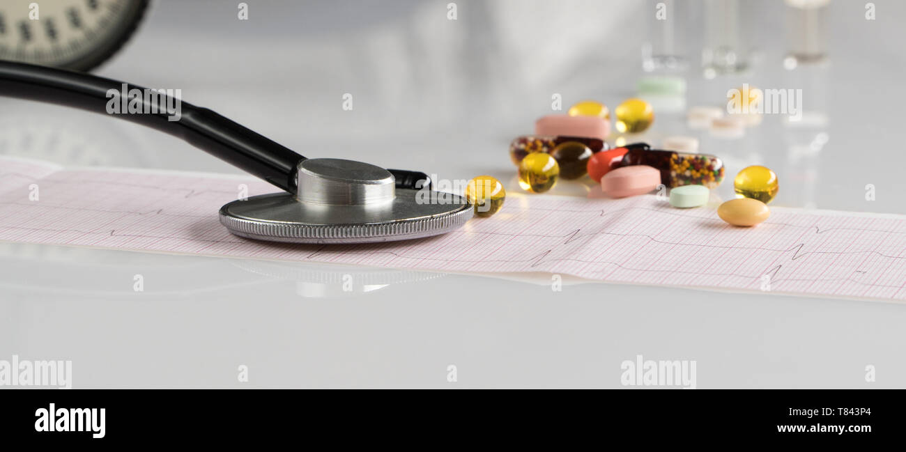 medical stethoscope with tonometer and ecg on a light background Stock ...