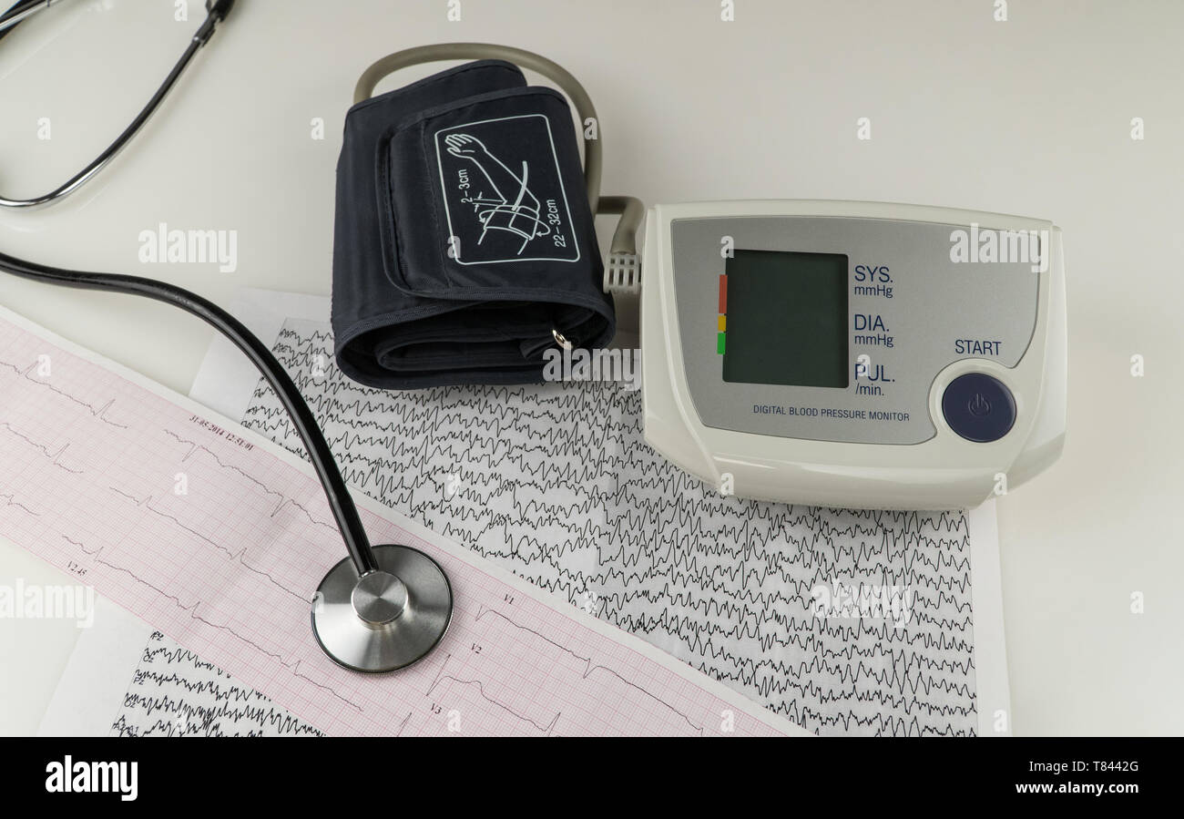 modern electric tonometer and a stethoscope on a cardiogram chart ...