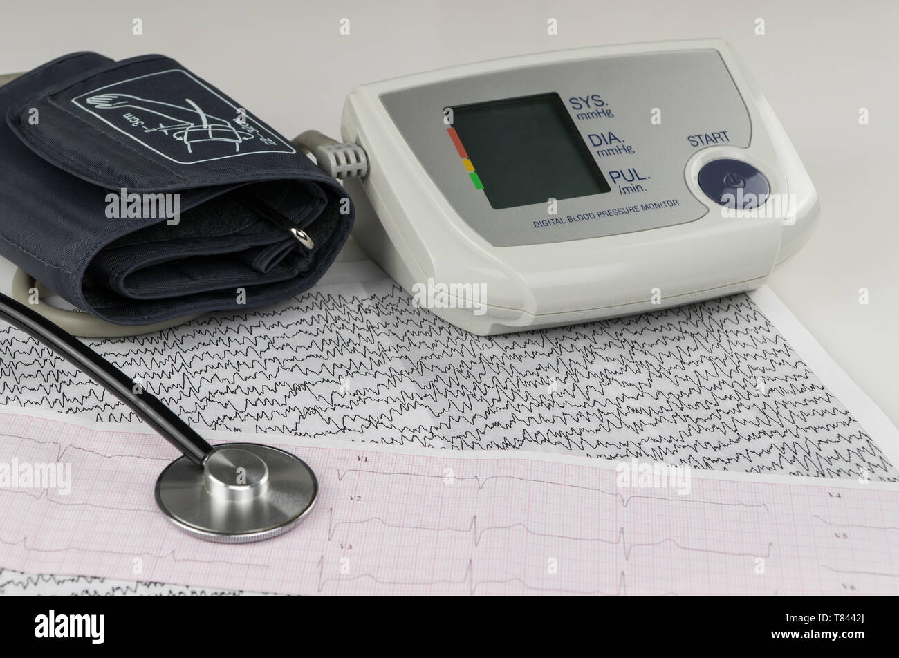 modern electric tonometer and a stethoscope on a cardiogram chart ...
