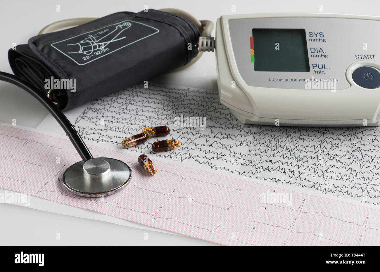 modern electric tonometer and a stethoscope on a cardiogram chart ...