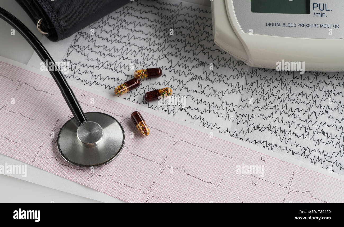 modern electric tonometer and a stethoscope on a cardiogram chart ...