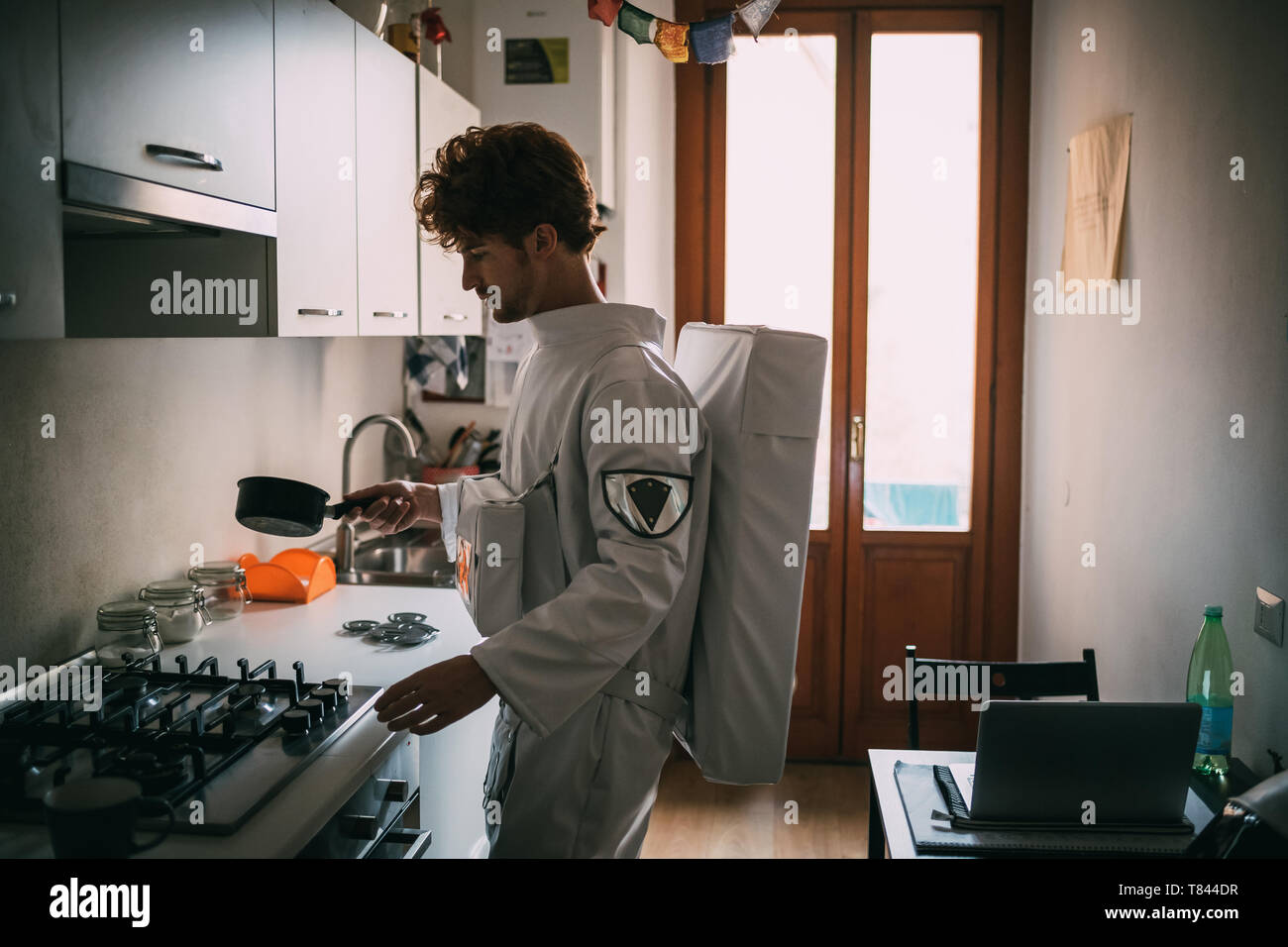 Astronaut cooking in kitchen Stock Photo - Alamy