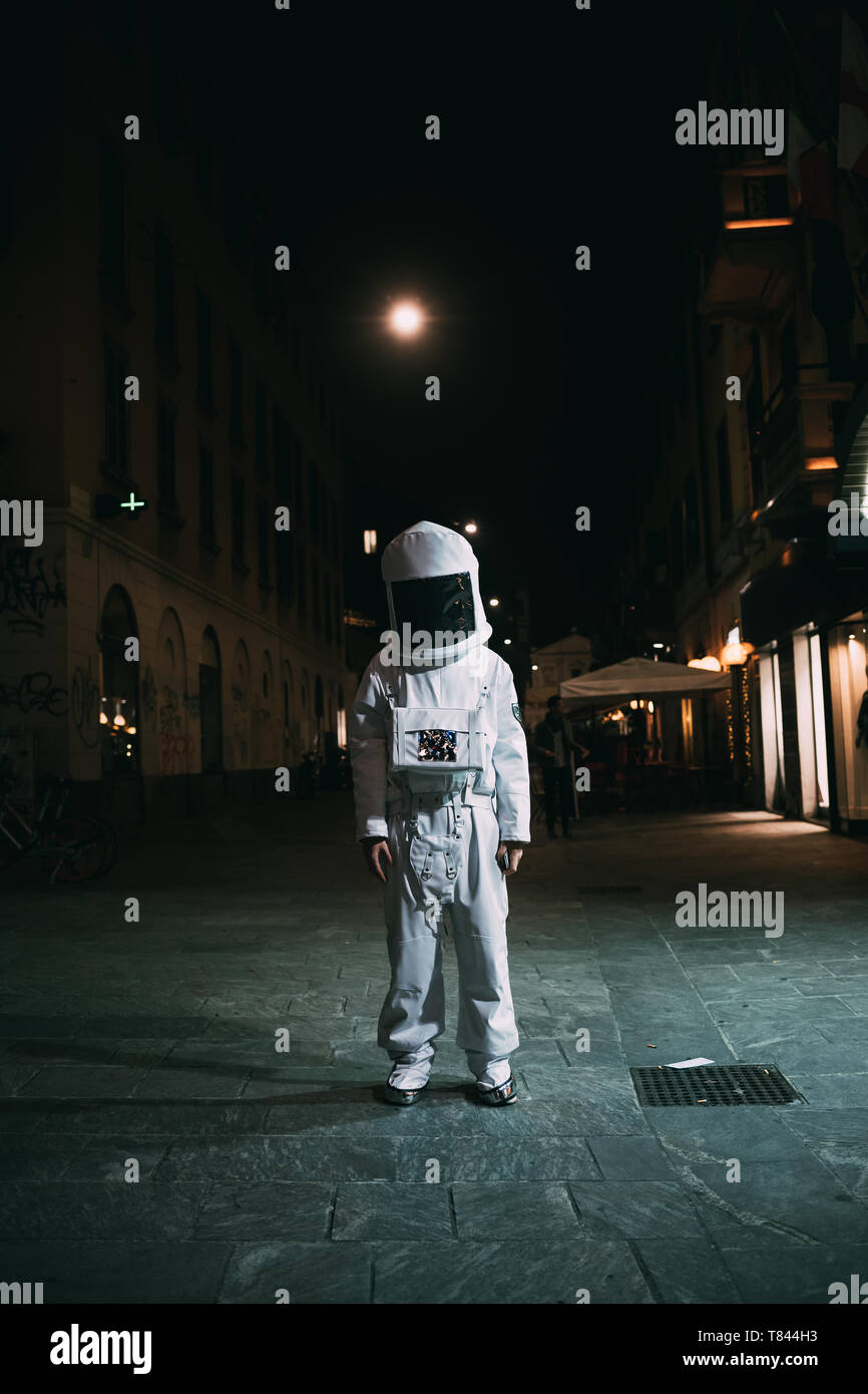 Astronaut on street at night Stock Photo - Alamy