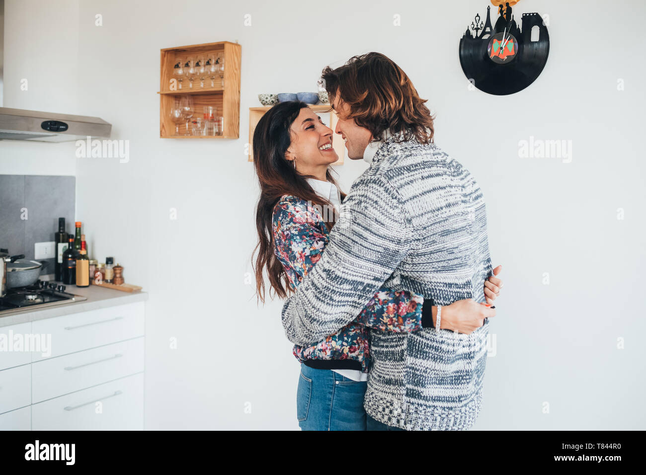 Couple hugging in kitchen Stock Photo - Alamy