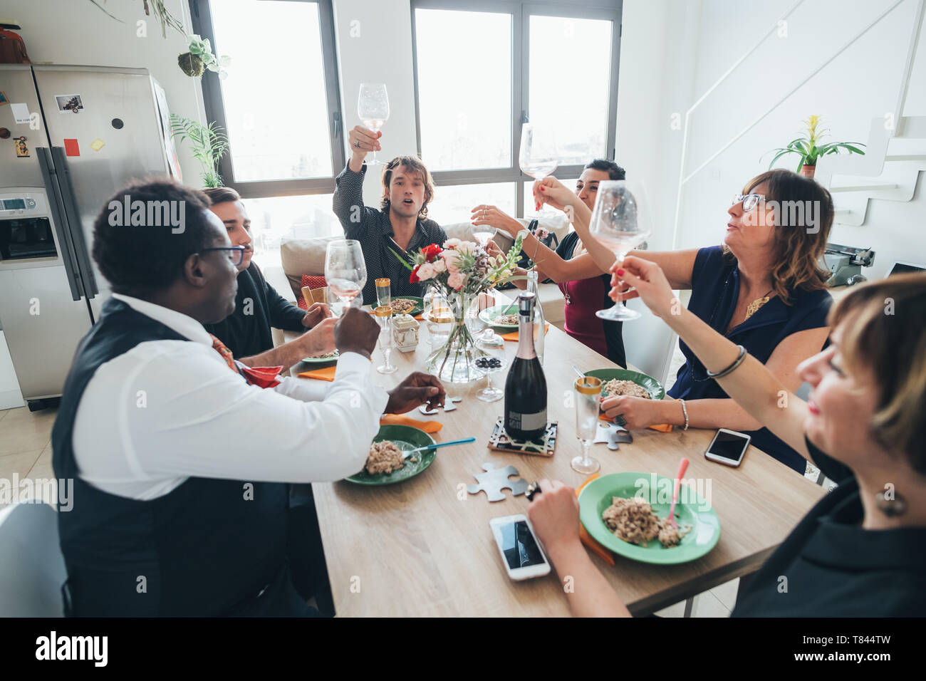 Businessmen and businesswomen celebrating at lunch party in loft office ...
