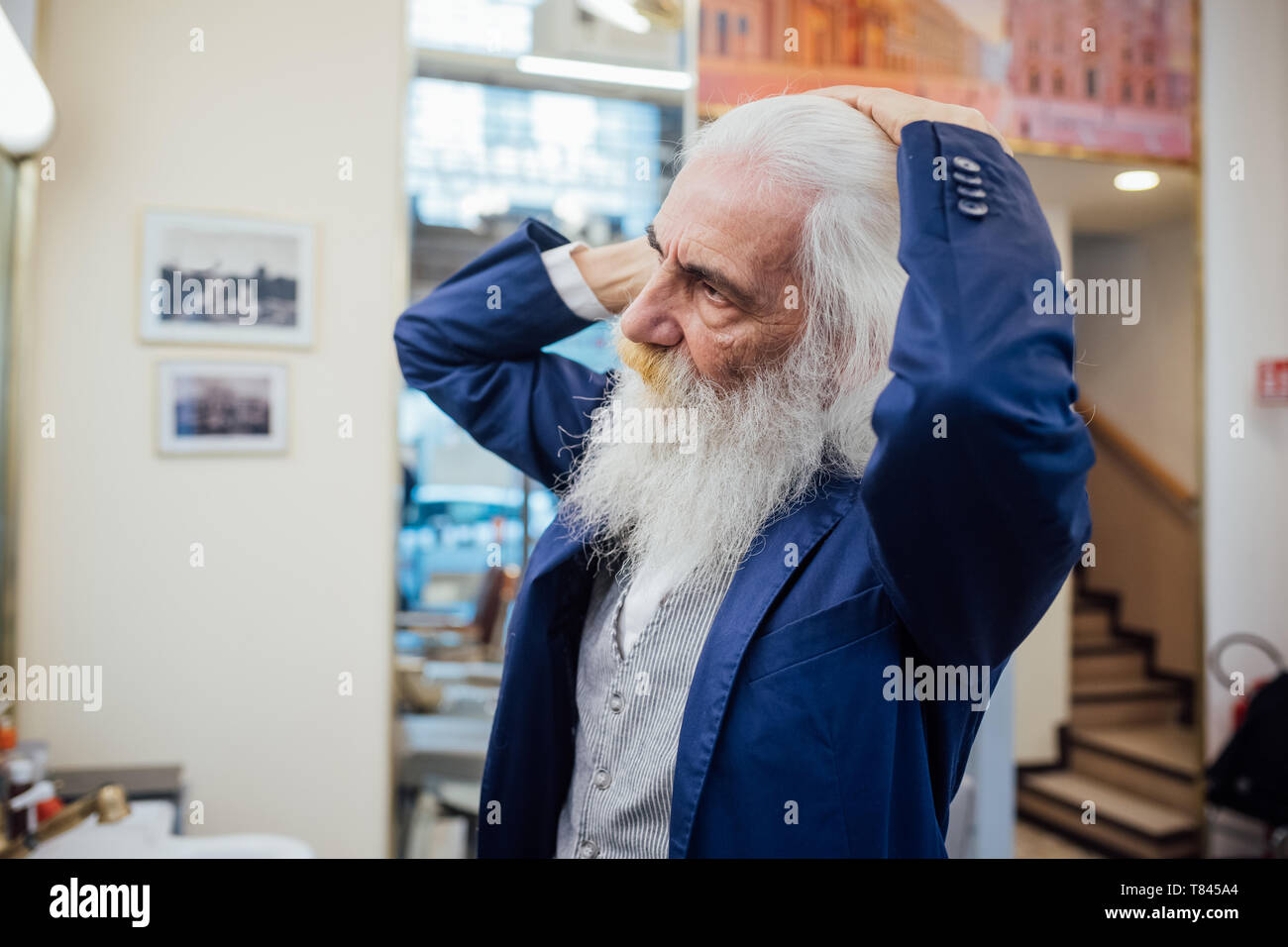 Senior businessman combing hair in salon Stock Photo - Alamy