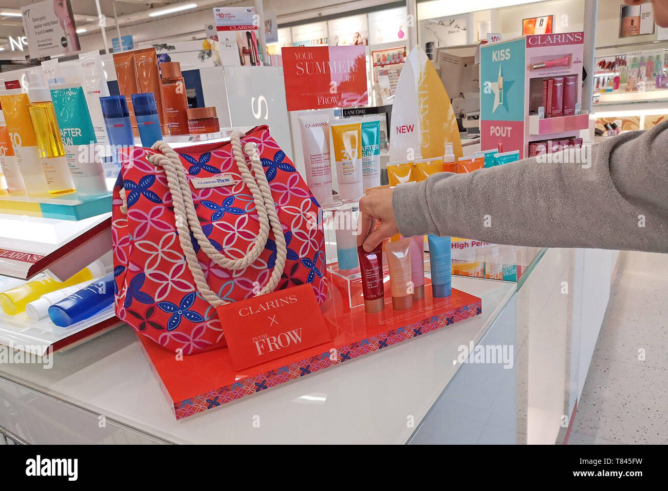 A customer looks at beauty products on the Clarins promotional stand in ...