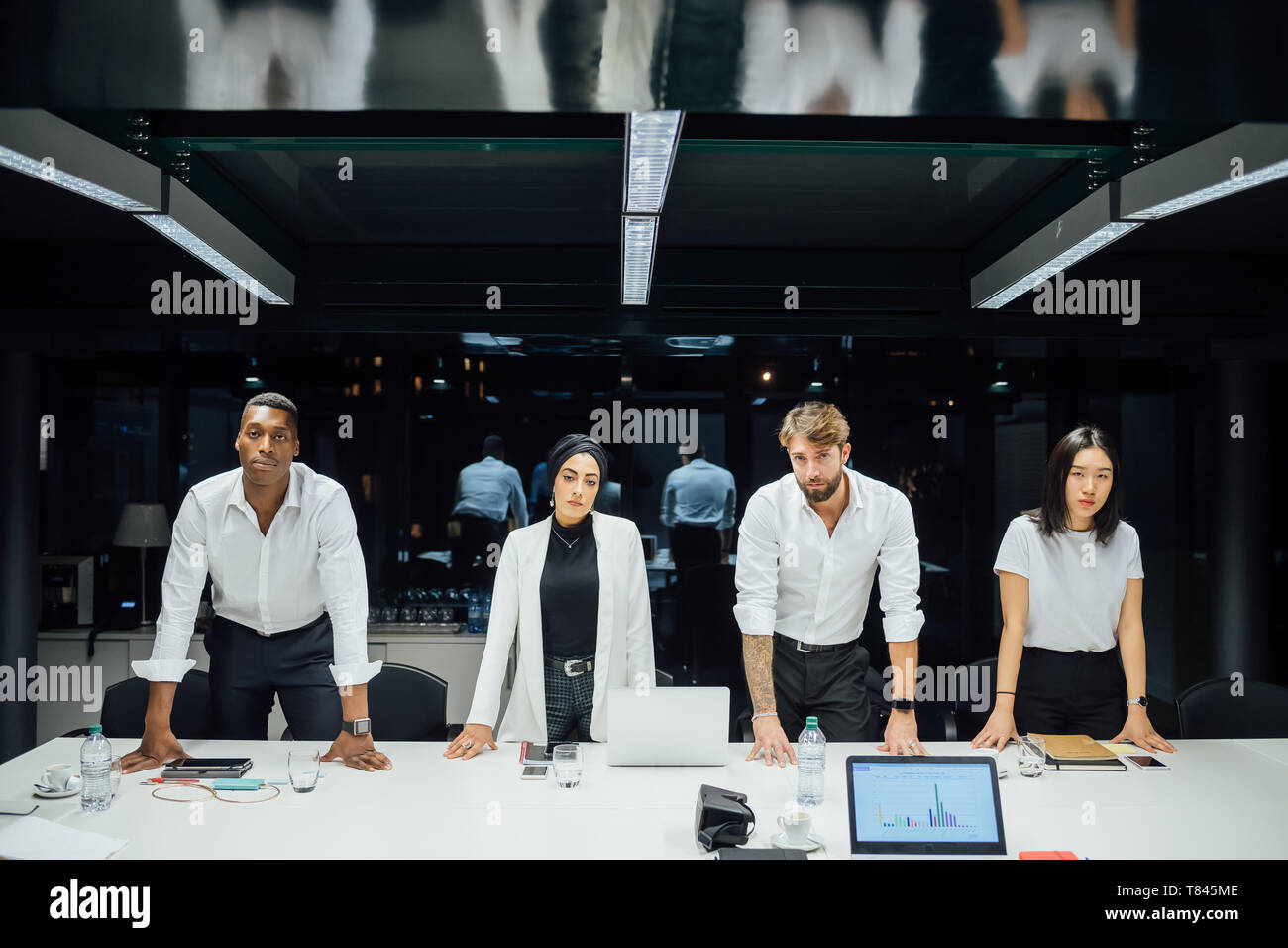 Confident business team at conference table meeting, portrait Stock ...