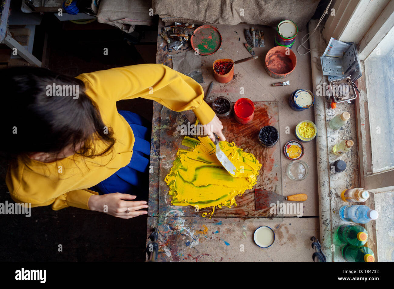 Woman creating art with scraper Stock Photo - Alamy