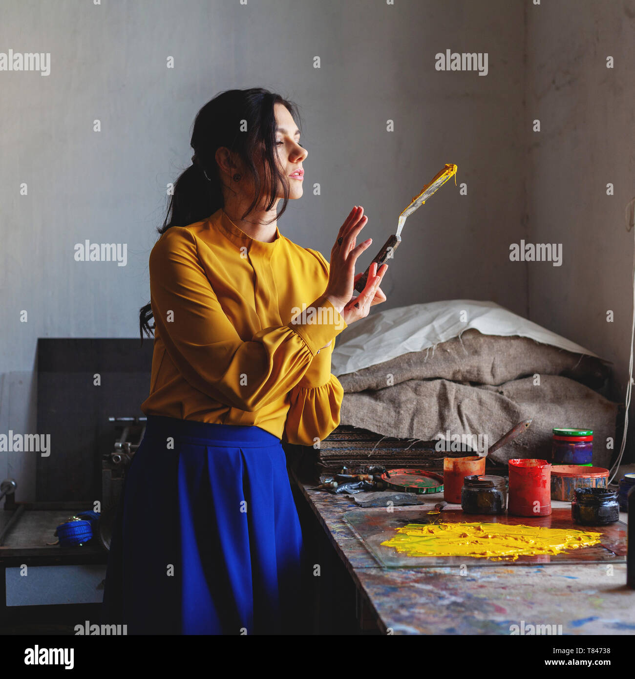 Woman creating art with scraper Stock Photo - Alamy
