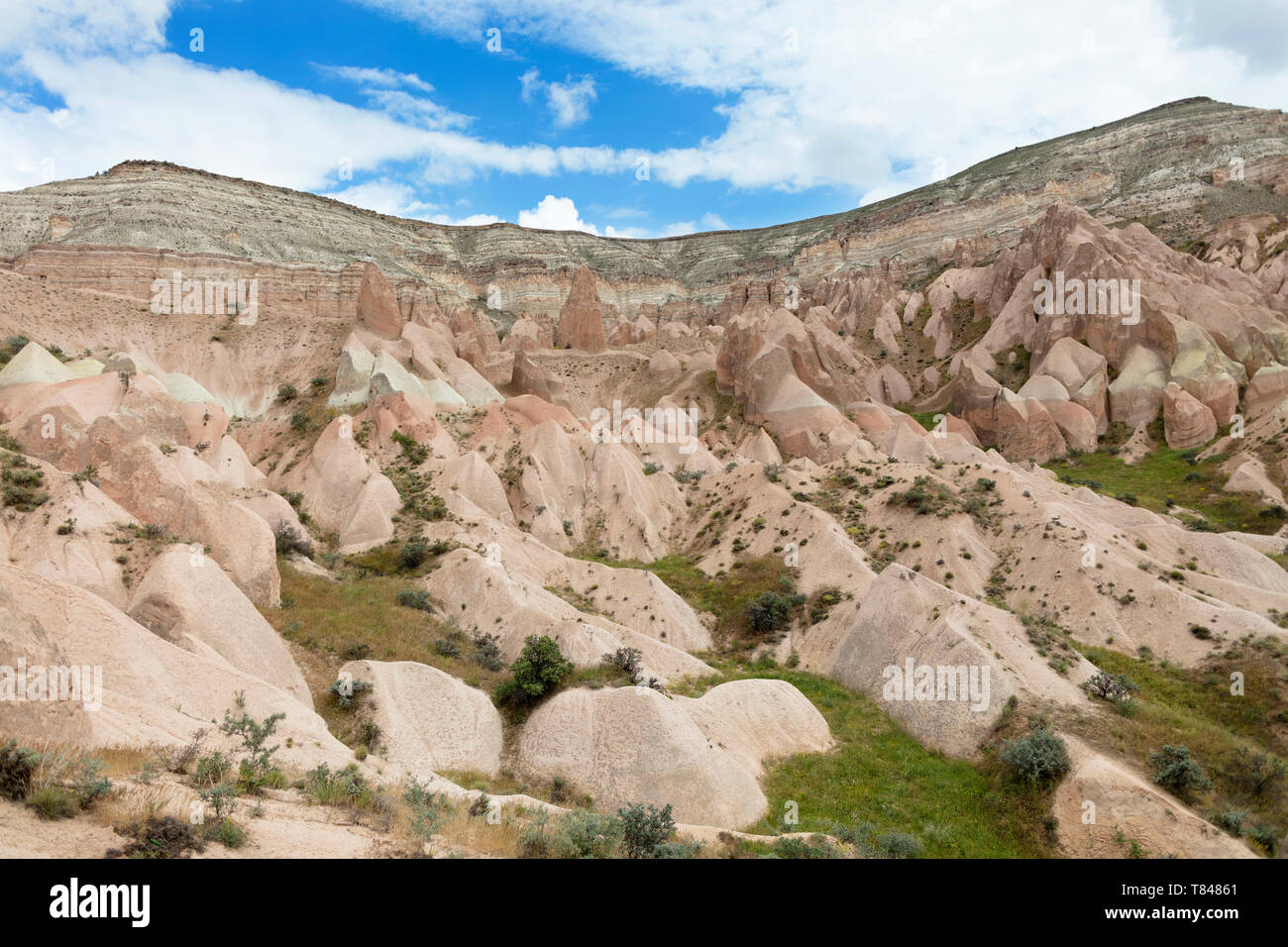 Red and white sandstone cliffs, ancient caves in a mountain landscape ...