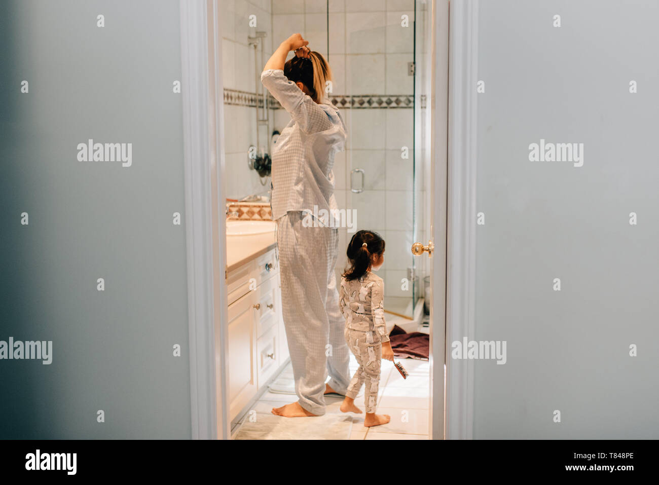 Girl and mother getting ready in bathroom Stock Photo - Alamy