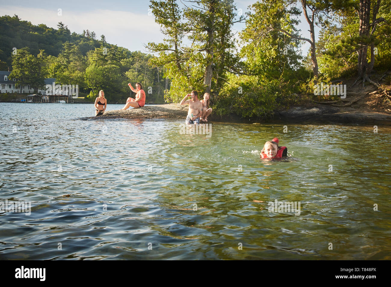 Family swimming in lake Stock Photo - Alamy