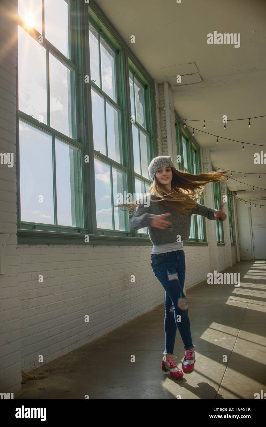Teenage girl with long brown hair spinning in dance studio, portrait ...