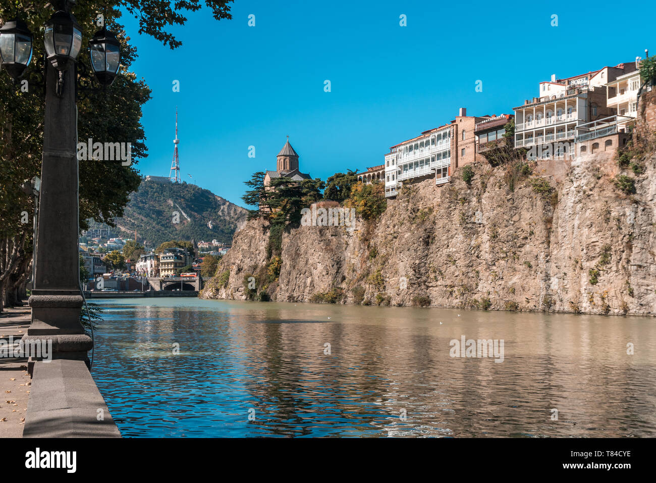 Metekhi church and Houses on the edge of a cliff above the river Kura ...