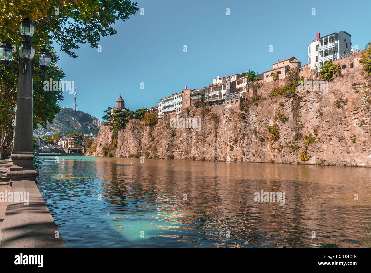 Metekhi church and Houses on the edge of a cliff above the river Kura ...