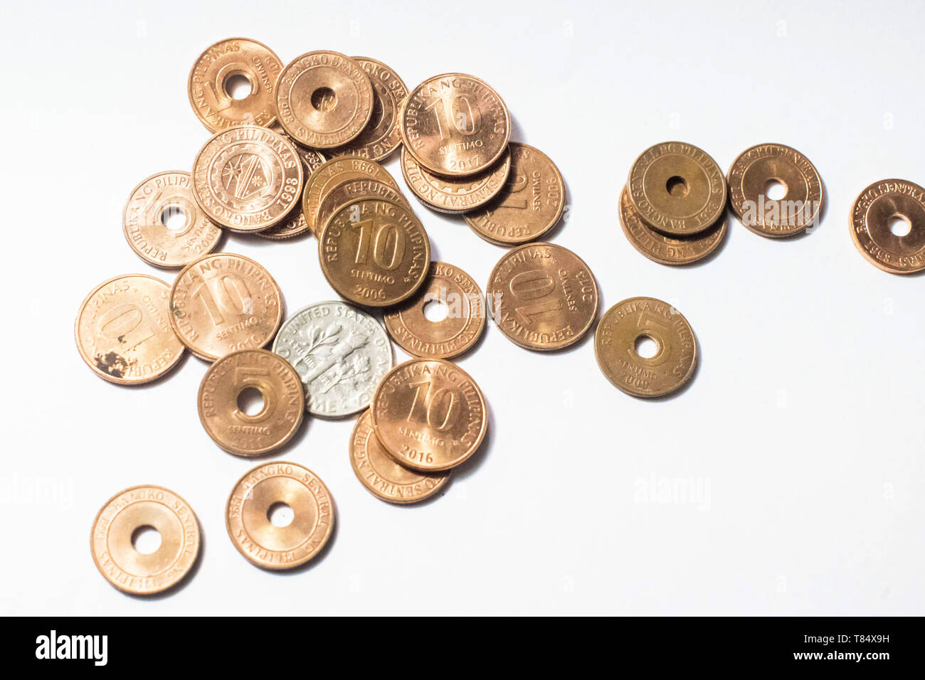 Scattered coins on white background Stock Photo - Alamy