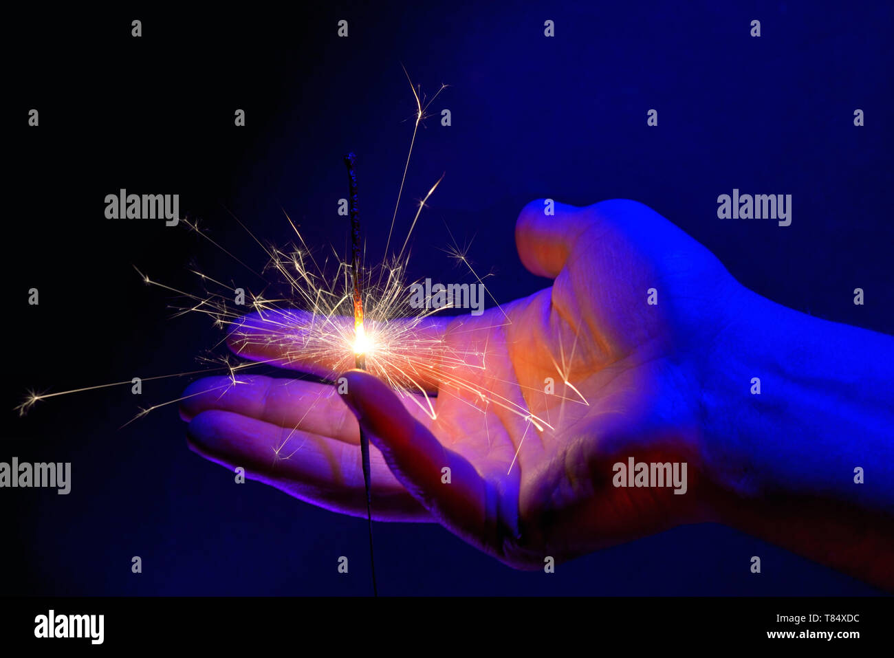 Hand Holding Fire Light Sparkler in night Stock Photo - Alamy