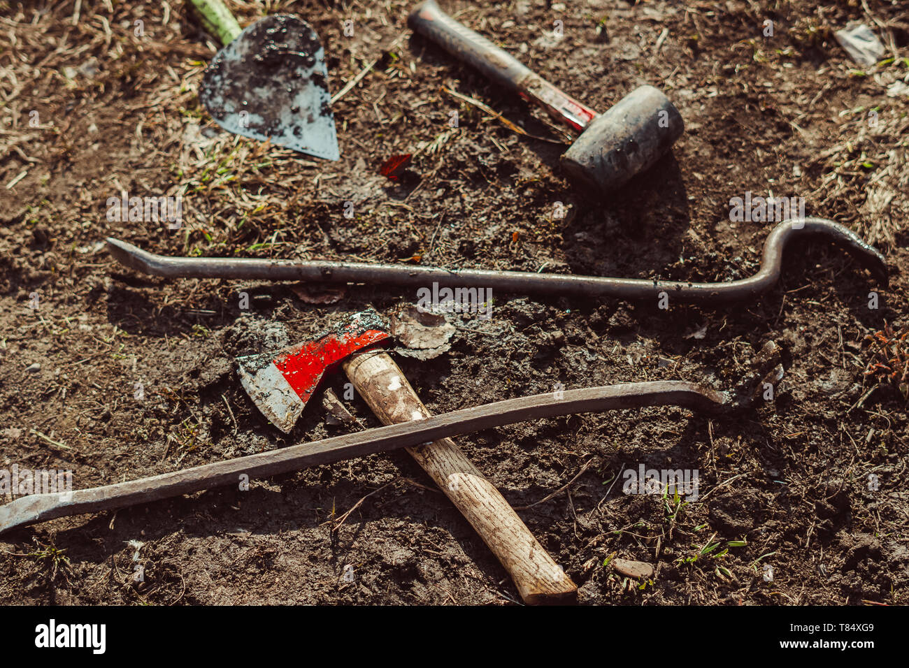 garden tools axe and crowbar lie on the ground Stock Photo Alamy