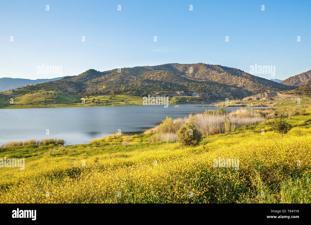 Cyprus landscape with mountains, lake and village Stock Photo - Alamy