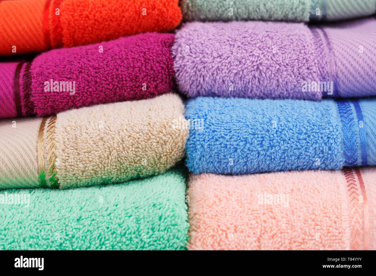 Colorful folded towels stack closeup picture Stock Photo - Alamy