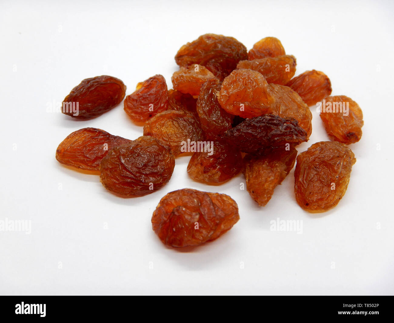 dried sultana fruits on white background Stock Photo - Alamy