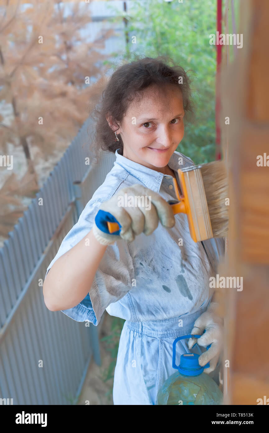 Attractive woman making biochemical impregnation against fire and bugs ...