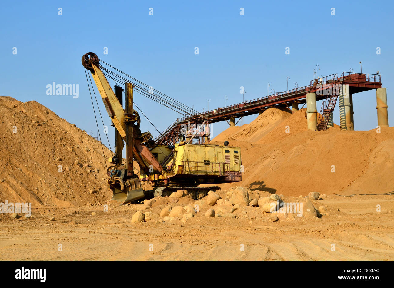 Large excavator in a quarry for the extraction of sand, gravel, rubble ...
