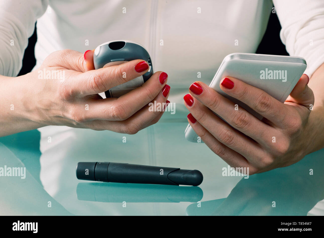 Using blood glucose meter and smart phone Stock Photo - Alamy
