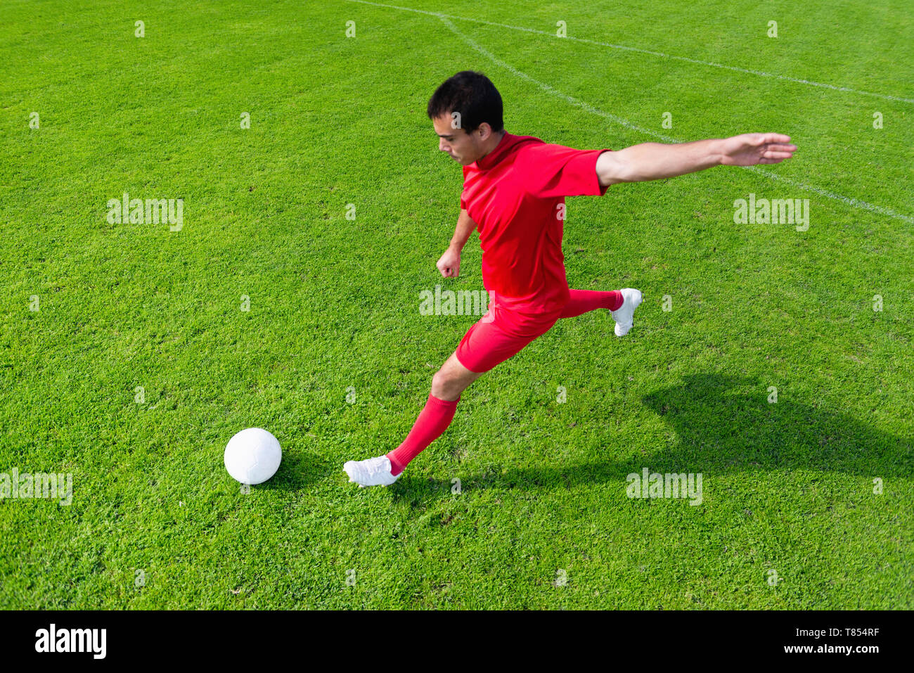 Soccer player kicking ball Stock Photo - Alamy