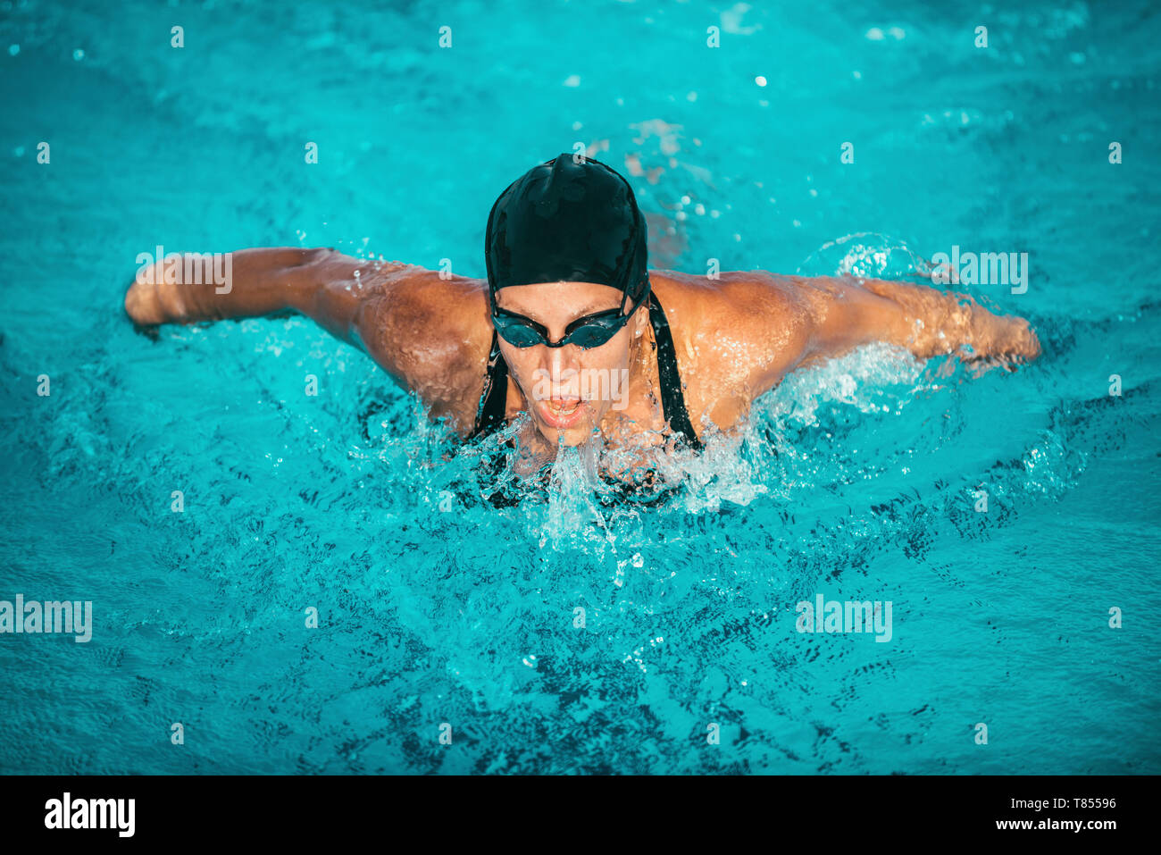 Woman swimming butterfly Stock Photo - Alamy
