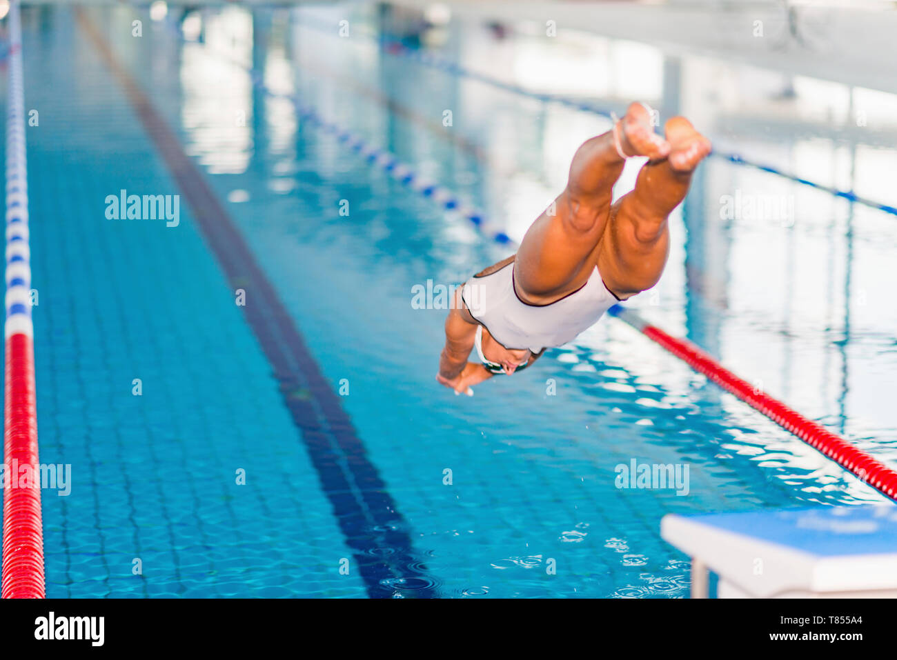 Woman diving into pool Stock Photo - Alamy
