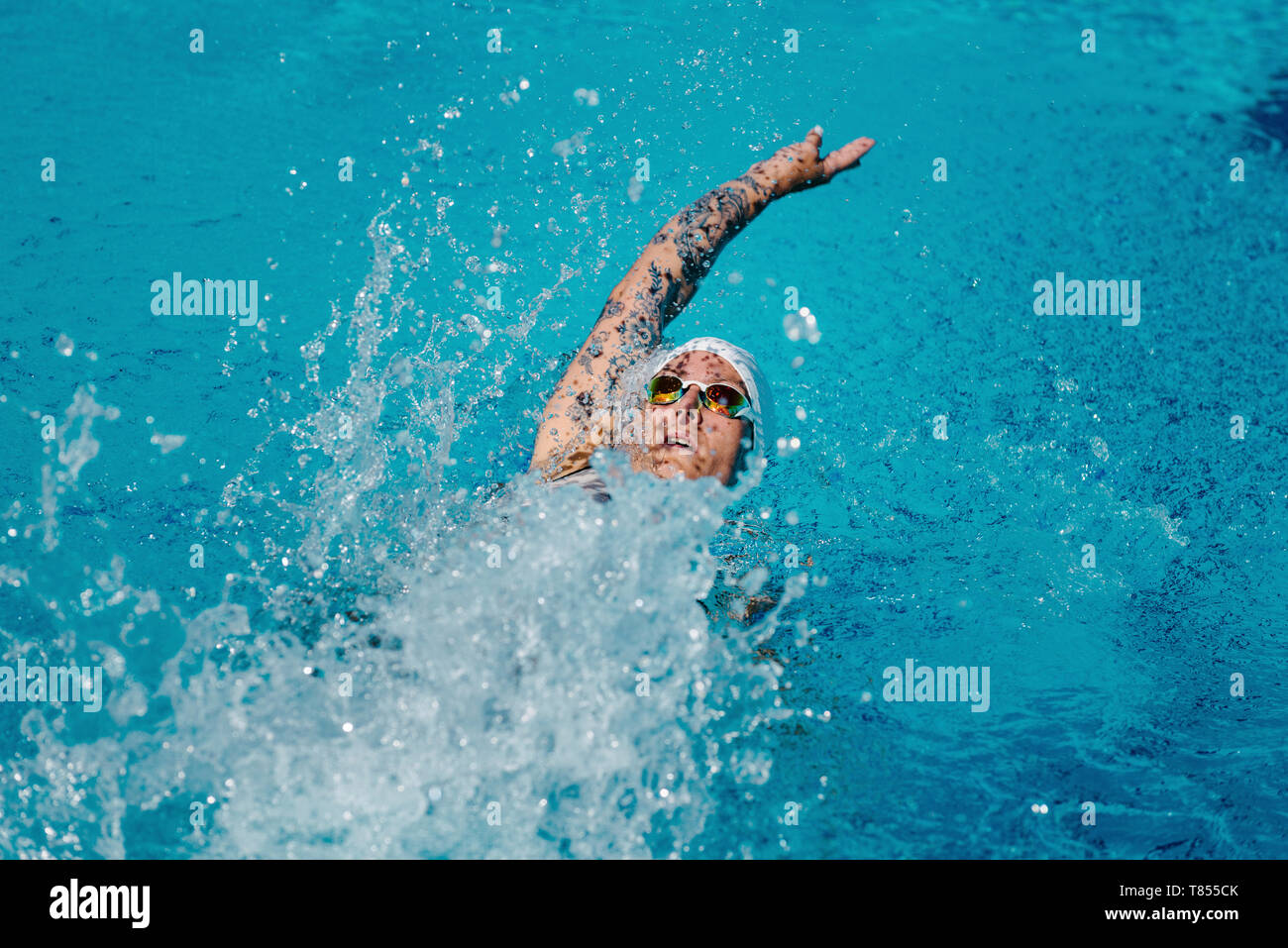 Woman swimming backstroke Stock Photo - Alamy