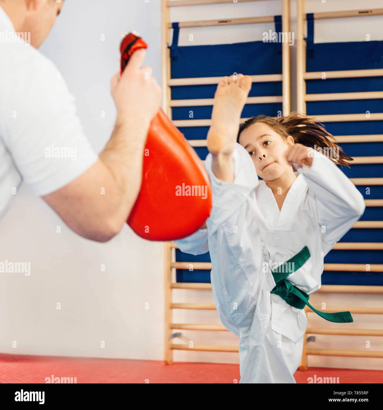 Taekwondo instructor working with girl Stock Photo - Alamy