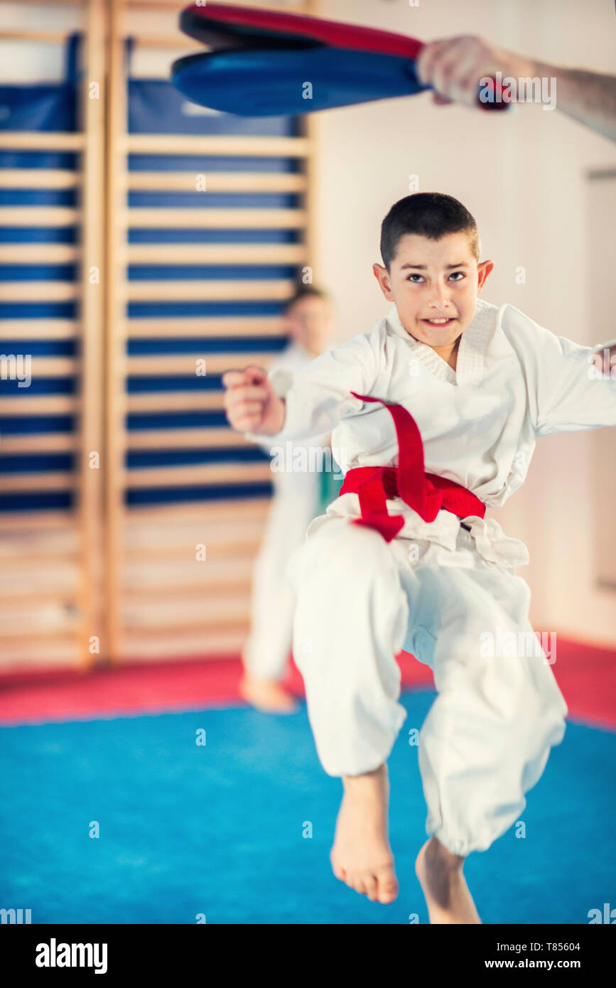 Taekwondo instructor working with boy Stock Photo - Alamy