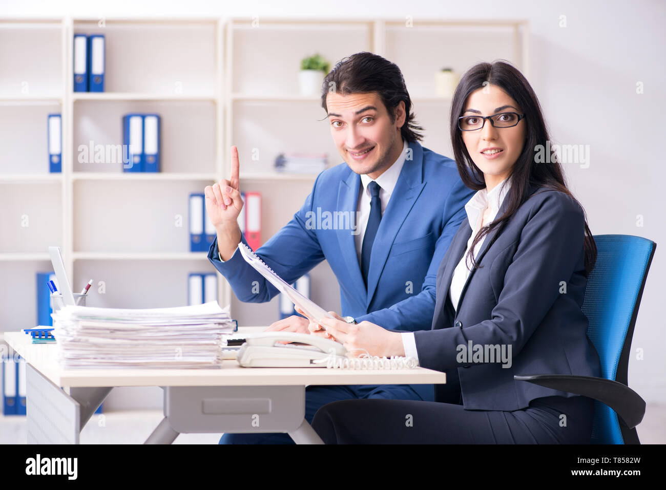 Two employees working in the office Stock Photo - Alamy