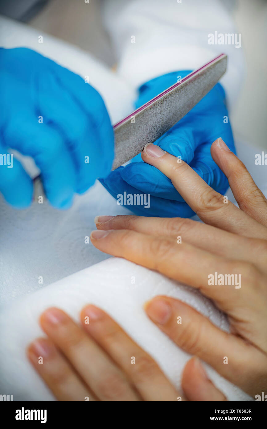 Female hands filing nails hi-res stock photography and images - Alamy